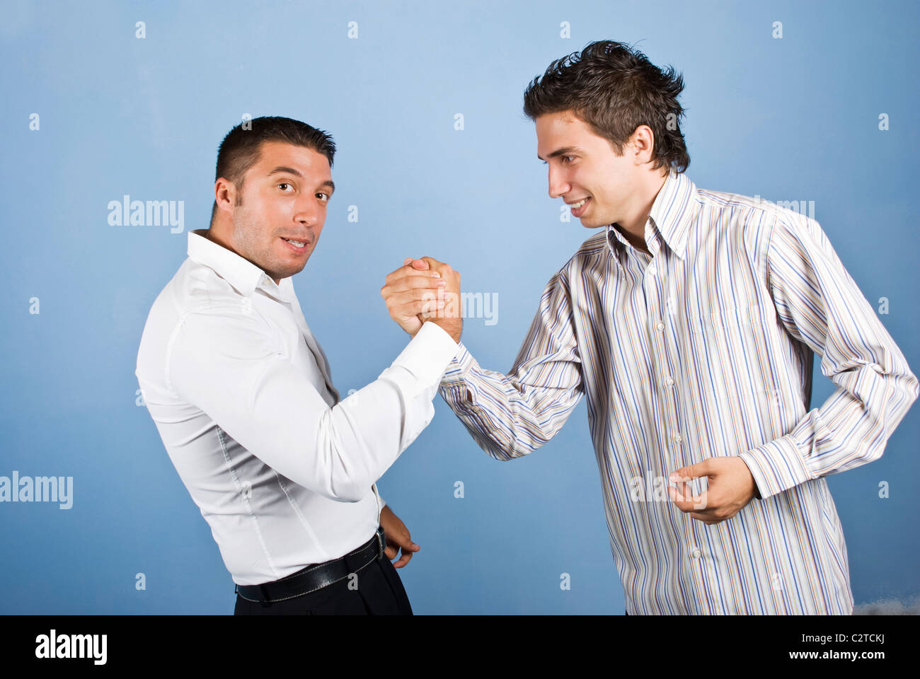 Two business man confrontation or fight in business isolated on blue ...