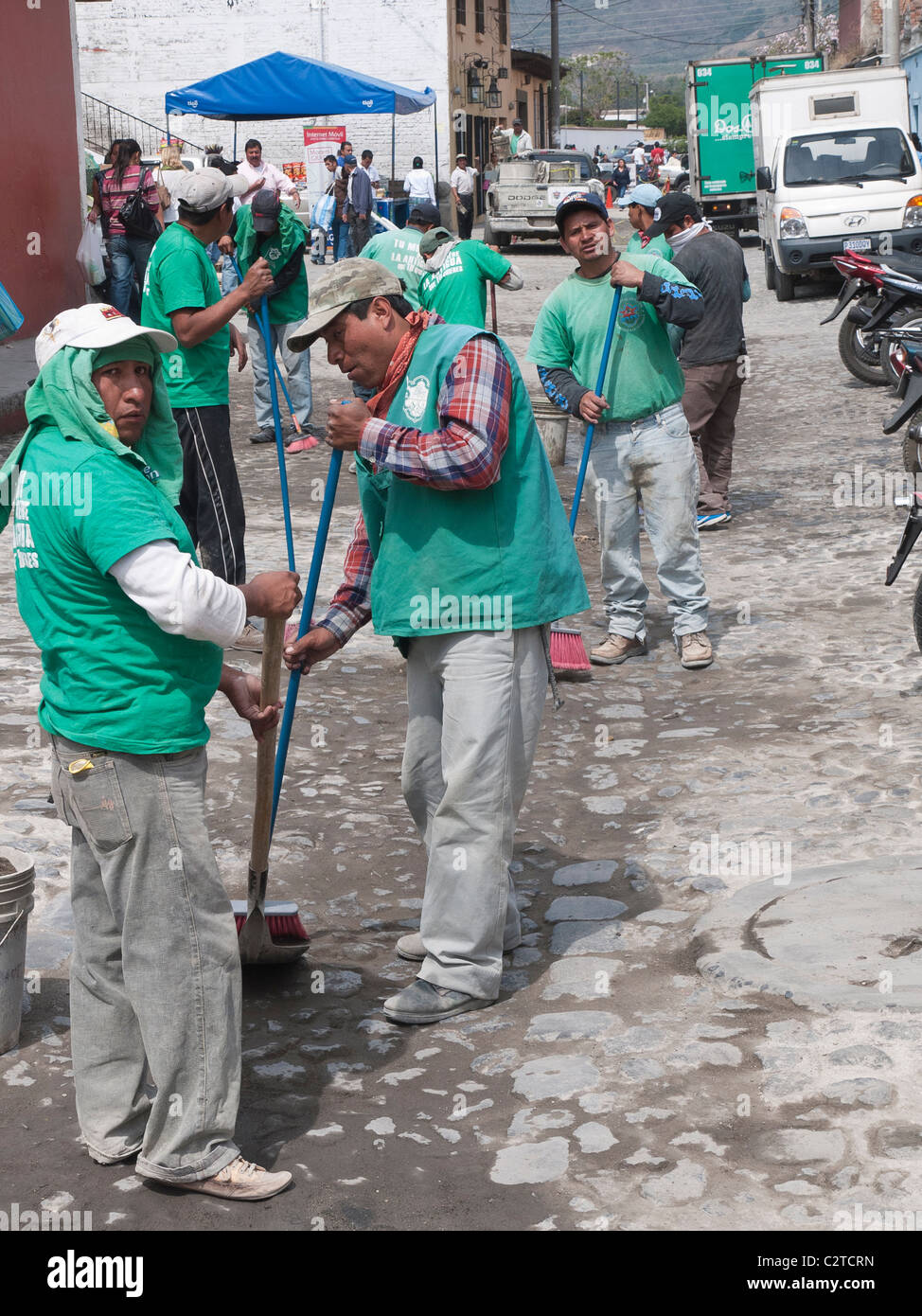 A city street repair crew works to repair a cobblestone street in the ...
