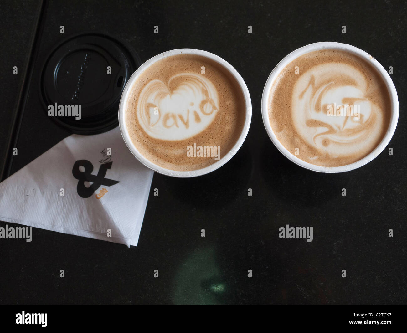Two cafe lattes viewed from the top to see the names of the customers ...