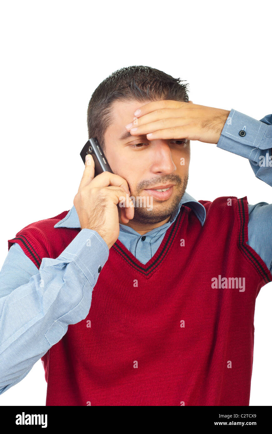 Confused man talking on phone mobile and holding hand on forehead ...