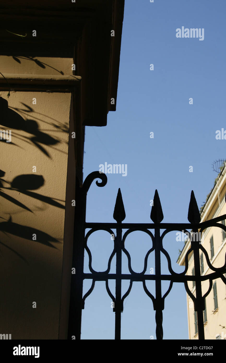 old gate shadow on property wall Stock Photo - Alamy