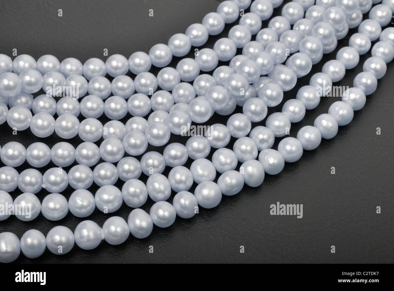 many strings of pearls on black Stock Photo - Alamy