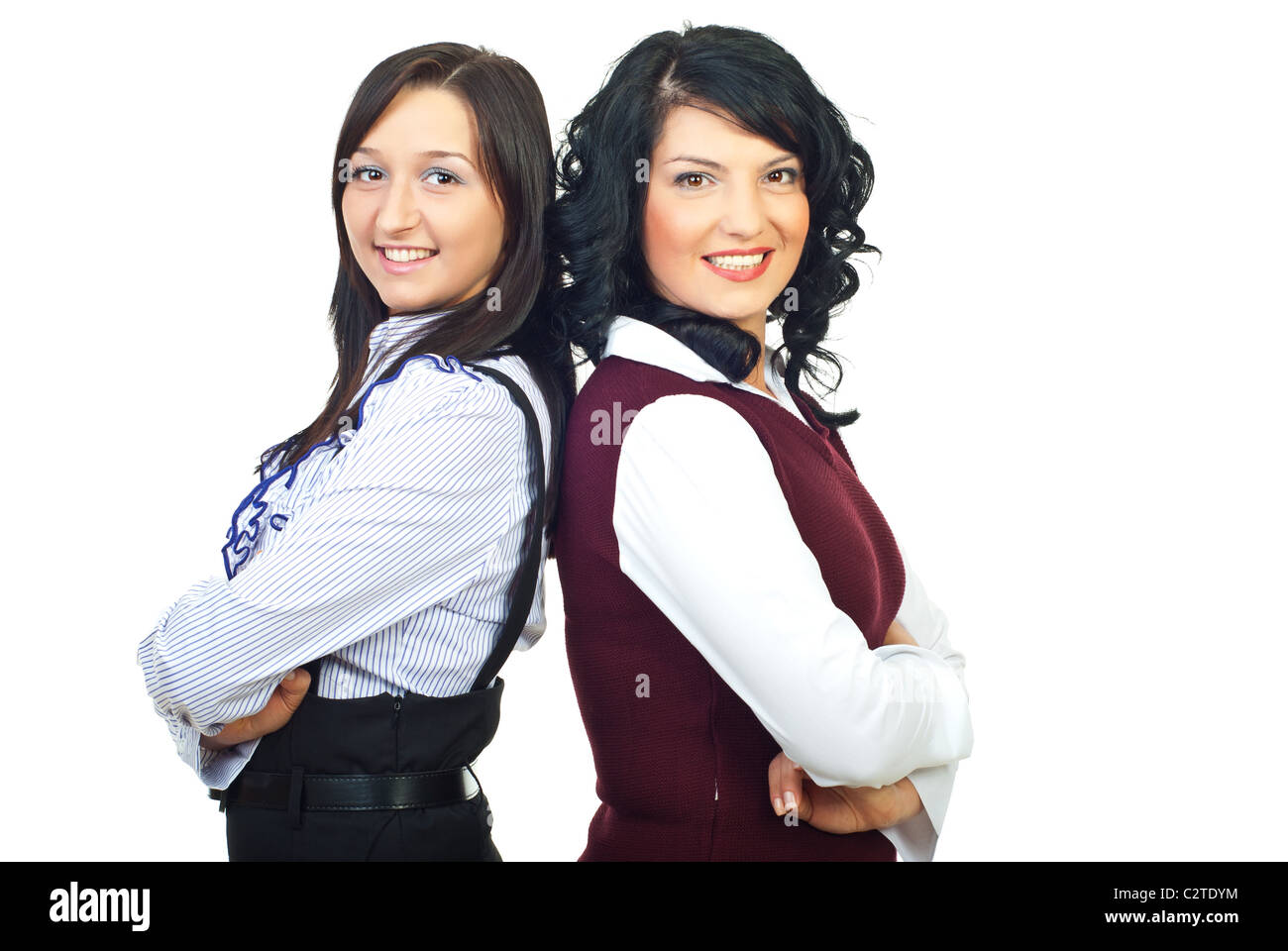 Attractive two business women standing back to back and looking at ...