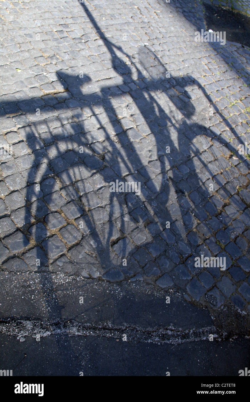 one bike bicycle shadow on cobbles street road in sun Stock Photo - Alamy