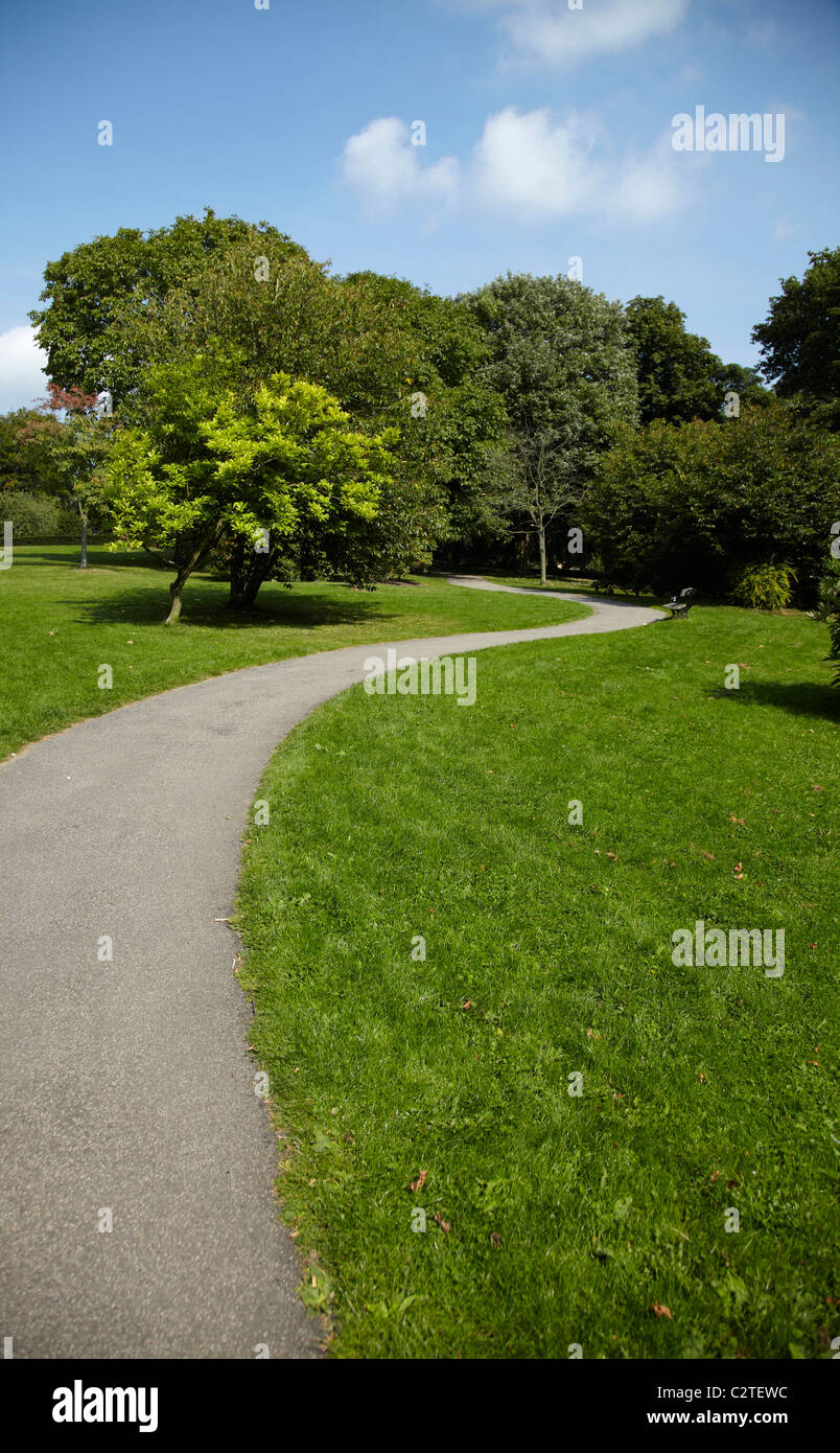 Path curving from viewpoint through public park shot on sunny day with ...