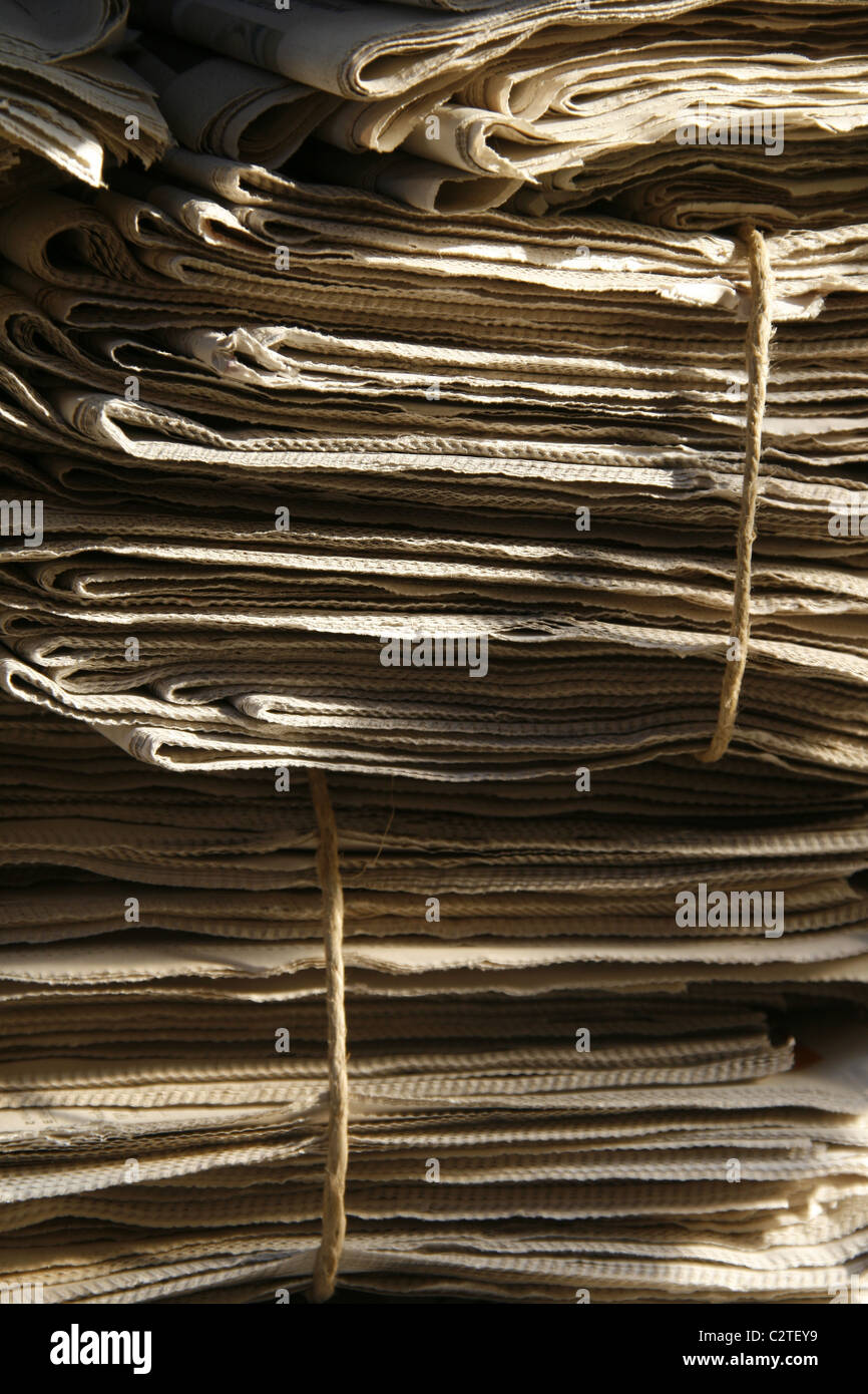 pile of old used newspapers left in street road in city town Stock ...