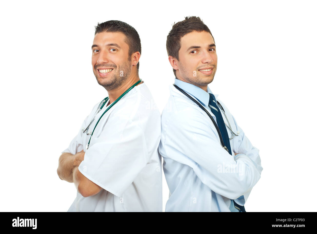 Two happy doctors men standing back to back with arms folded isolated ...