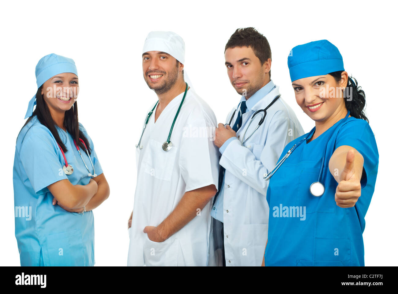 Happy surgeon woman giving thumbs up and her team smiling in background ...