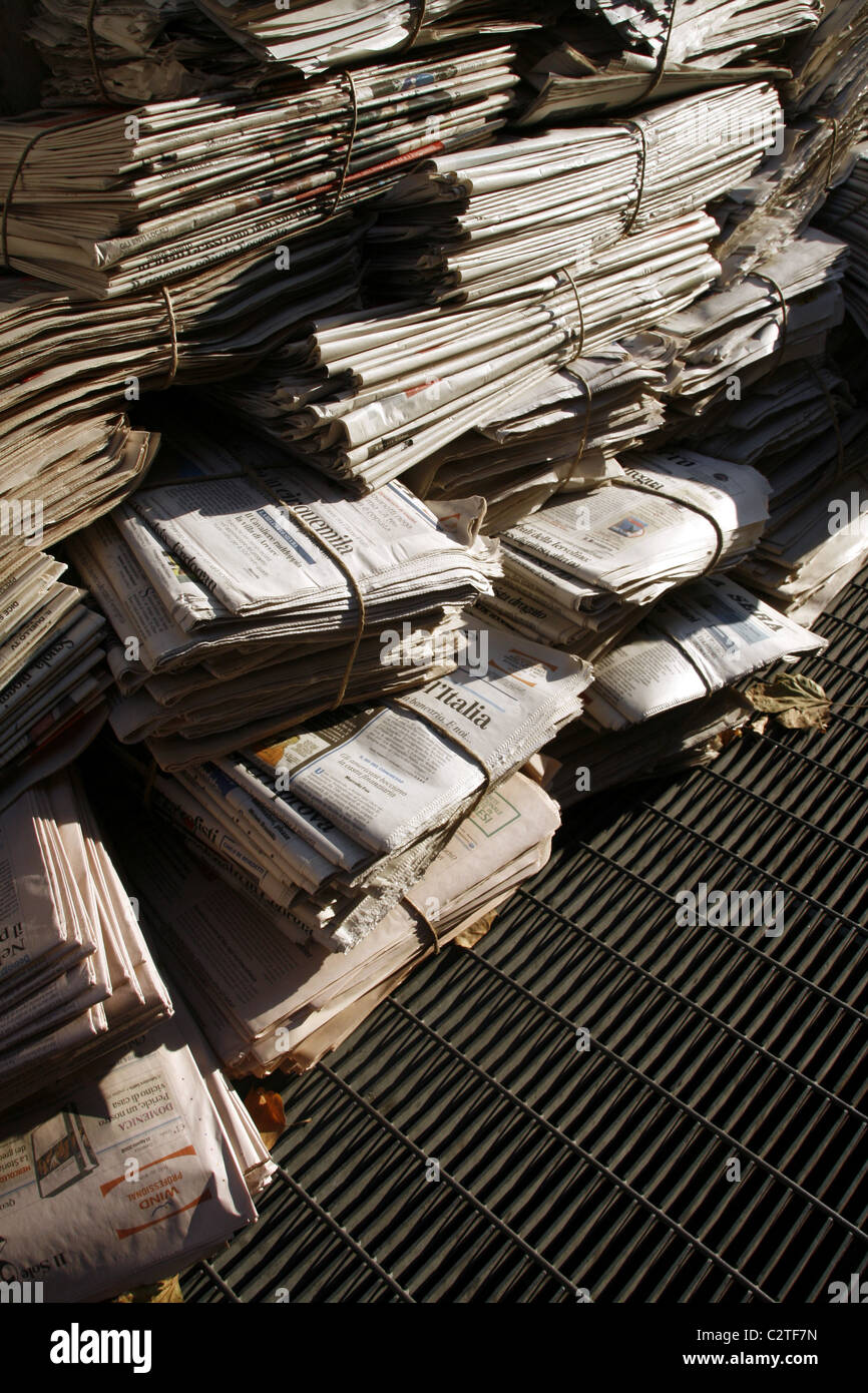 pile of old used newspapers left in street road in city town Stock ...