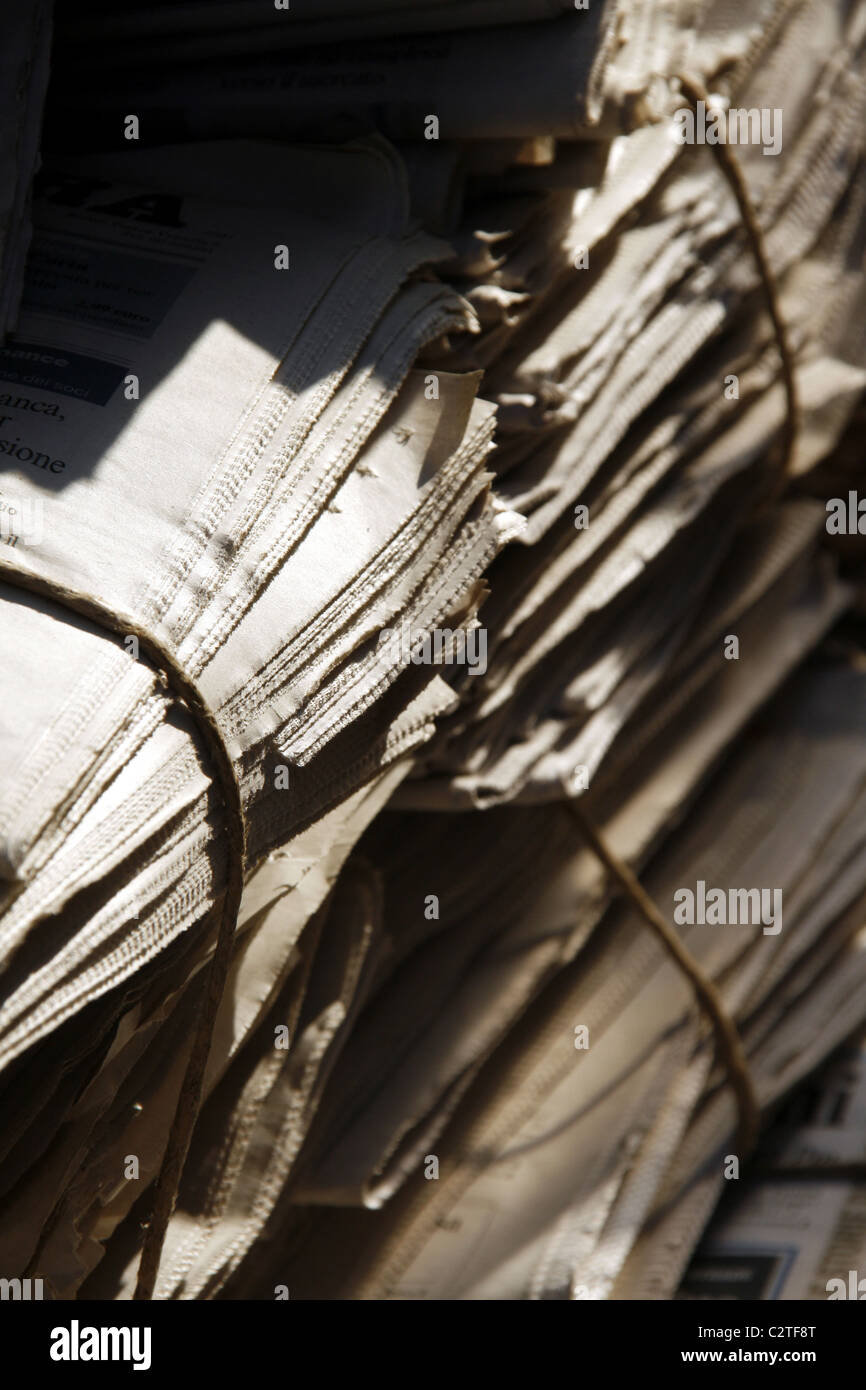 pile of old used newspapers left in street road in city town Stock ...
