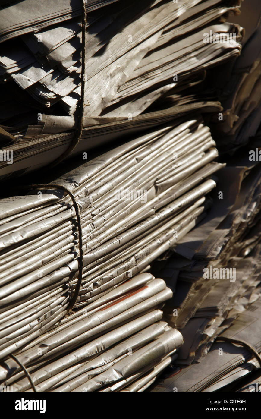 pile of old used newspapers left in street road in city town Stock ...