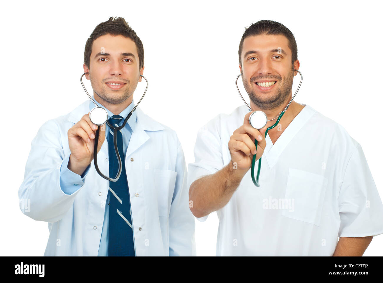 Two happy friendly doctors holding their stethoscopes isolated on white ...