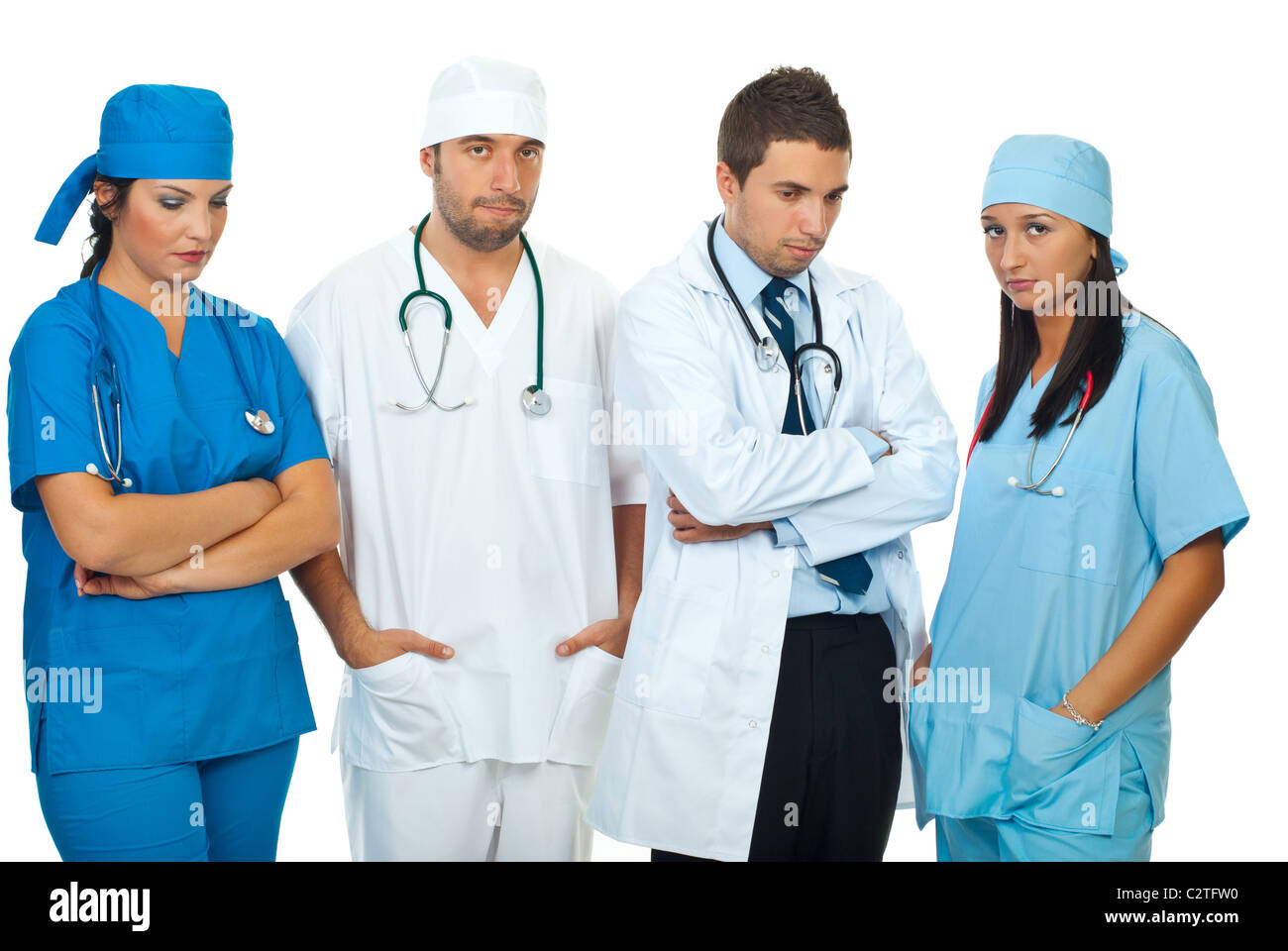 Disappointed team of different doctors standing in a row and looking ...