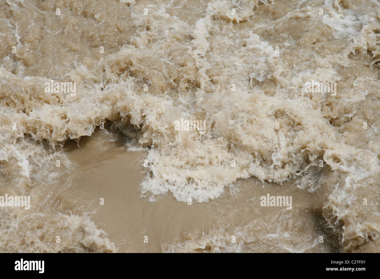 fast brown rapid flood water in river Stock Photo - Alamy