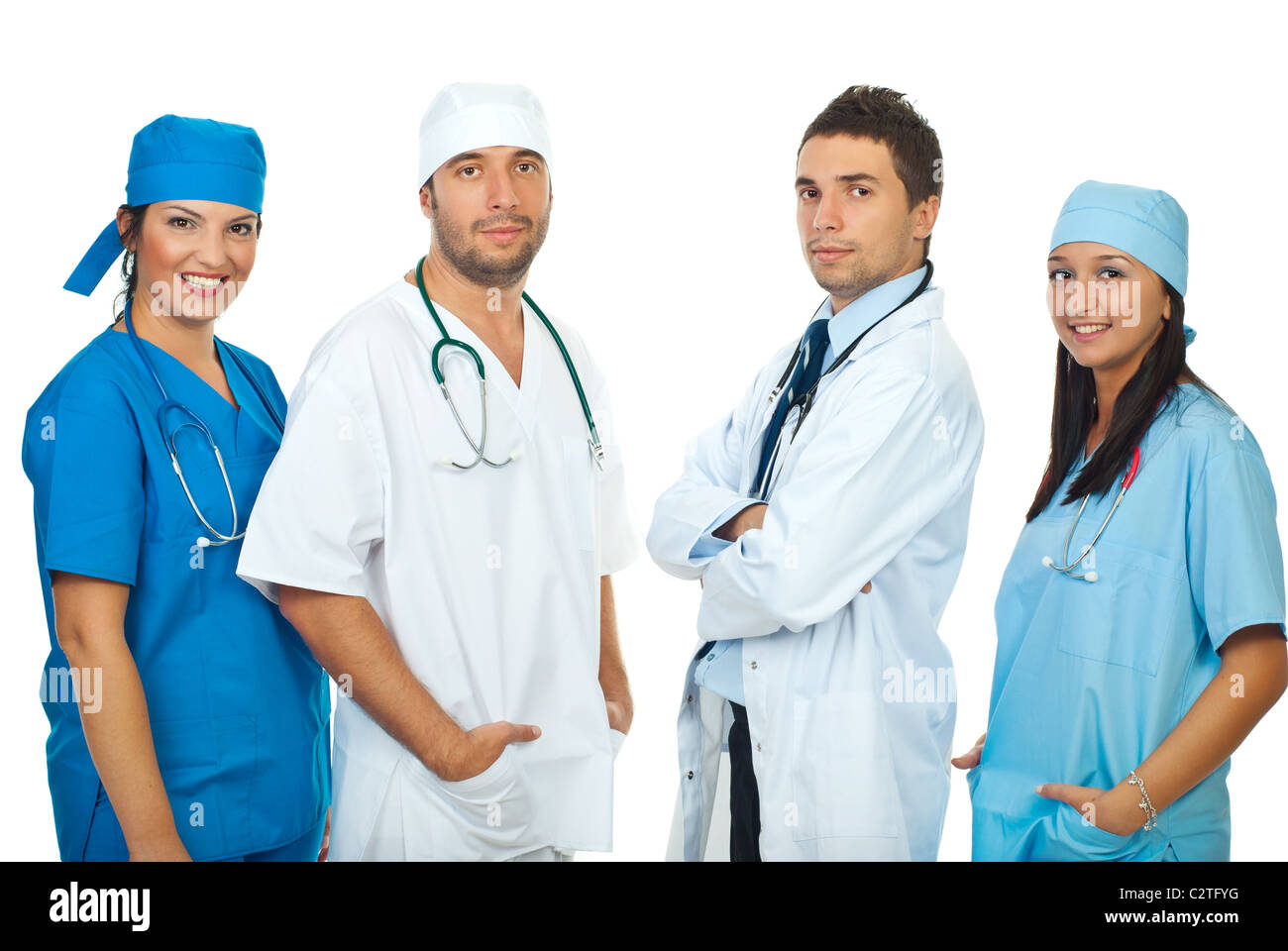 Friendly four different doctors standing in a row isolated on white ...