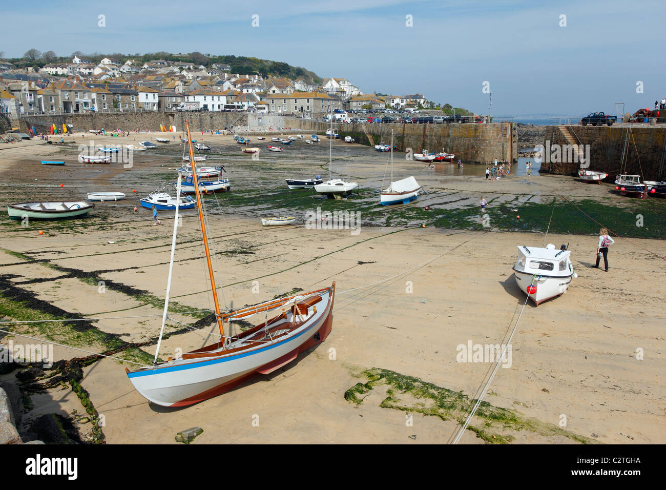 Mousehole harbour on a low spring tide, Cornwall UK Stock Photo - Alamy