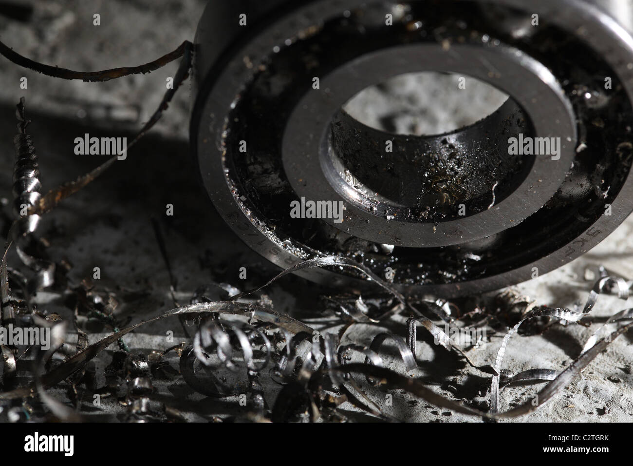 Damaged bearing surrounded by metal swarf Stock Photo - Alamy