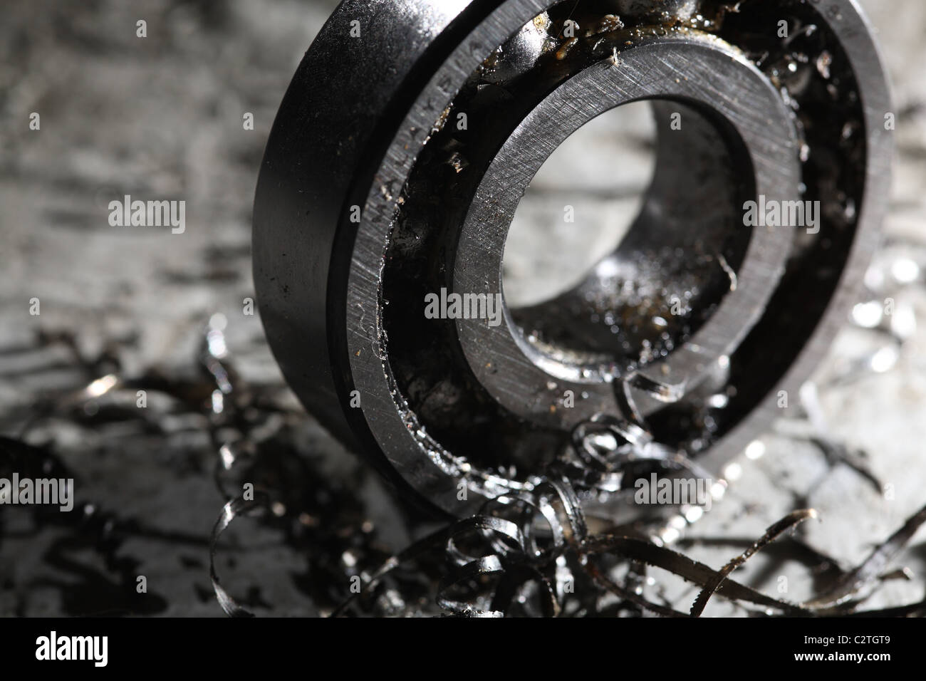 Damaged bearing surrounded by metal swarf Stock Photo - Alamy