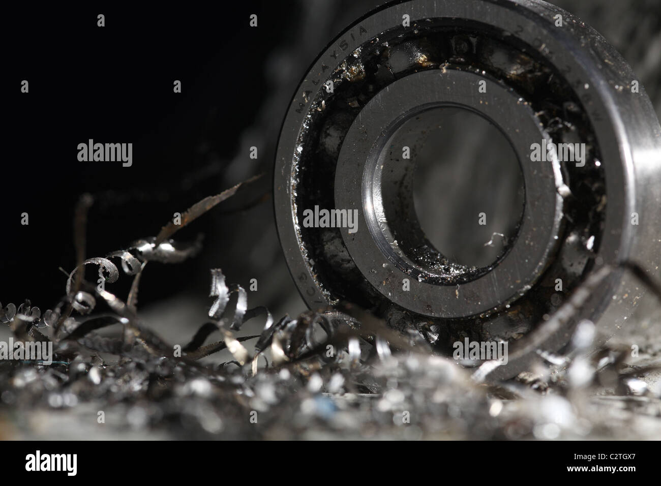 Damaged bearing surrounded by metal swarf Stock Photo - Alamy