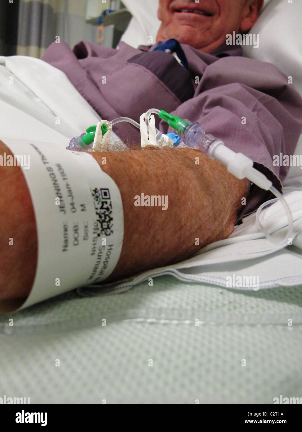 elderly mans arm in hospital with name tag and drip Stock Photo - Alamy