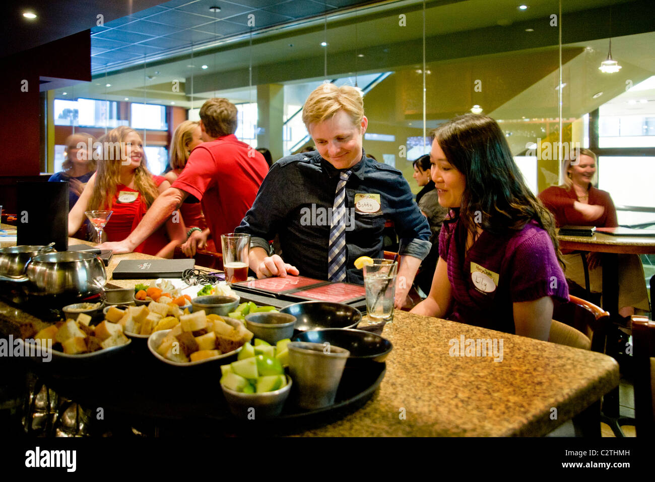 Speed dating participants socialize in the bar of a California ...