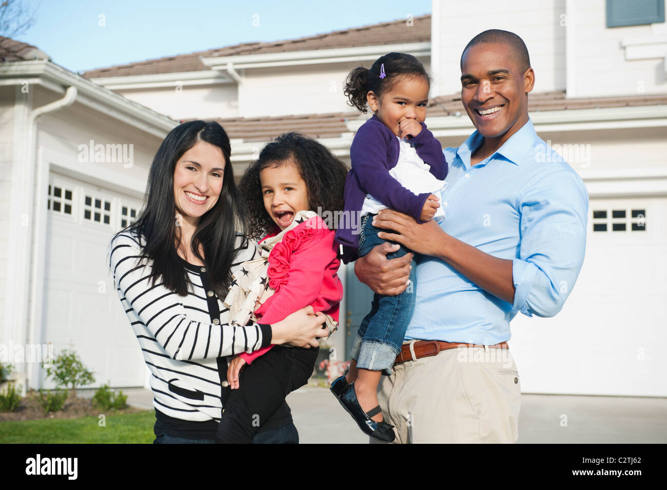 Proud parents and daughter standing in driveway Stock Photo - Alamy