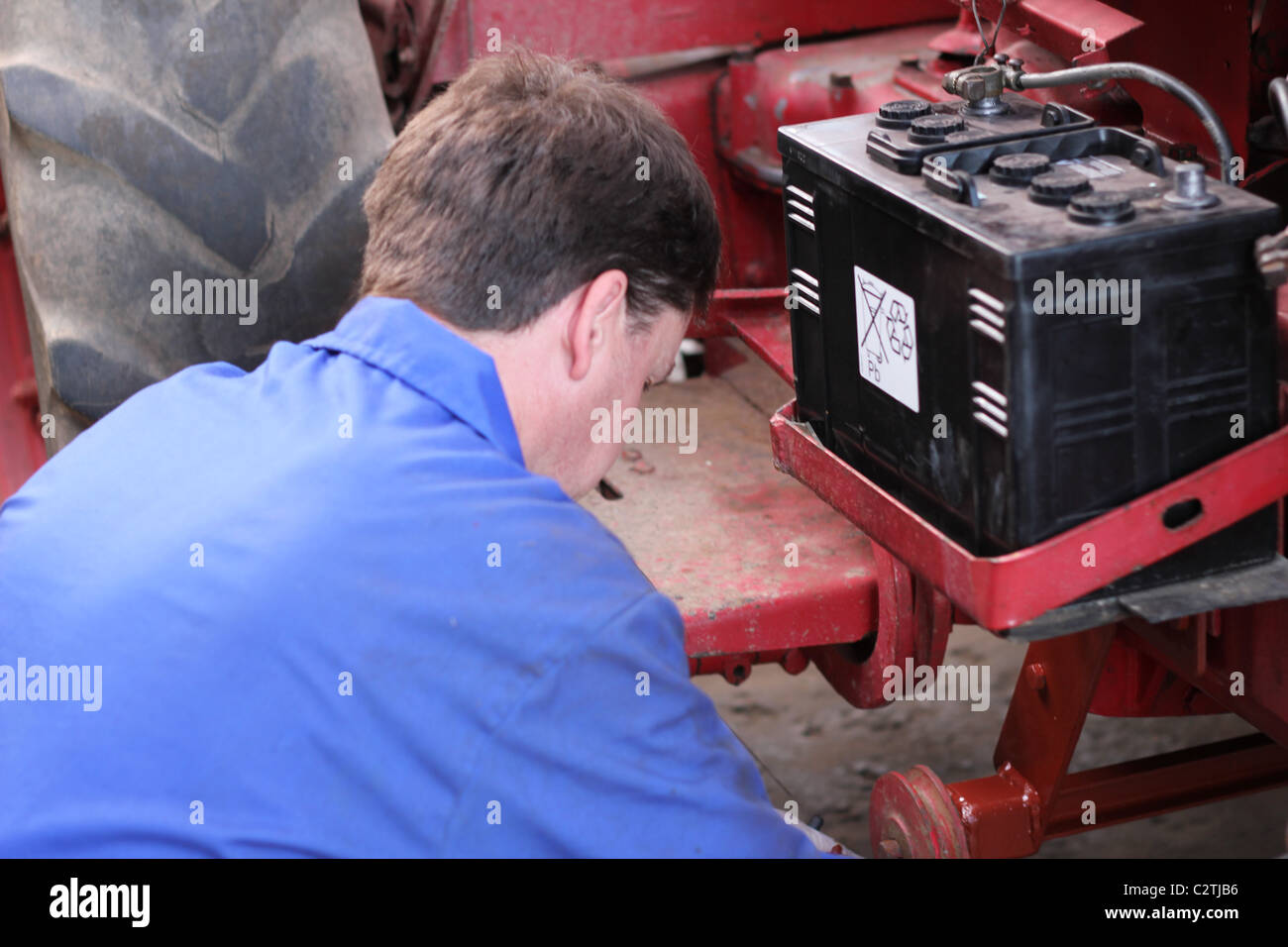 Man working on a vintage tractor Stock Photo - Alamy