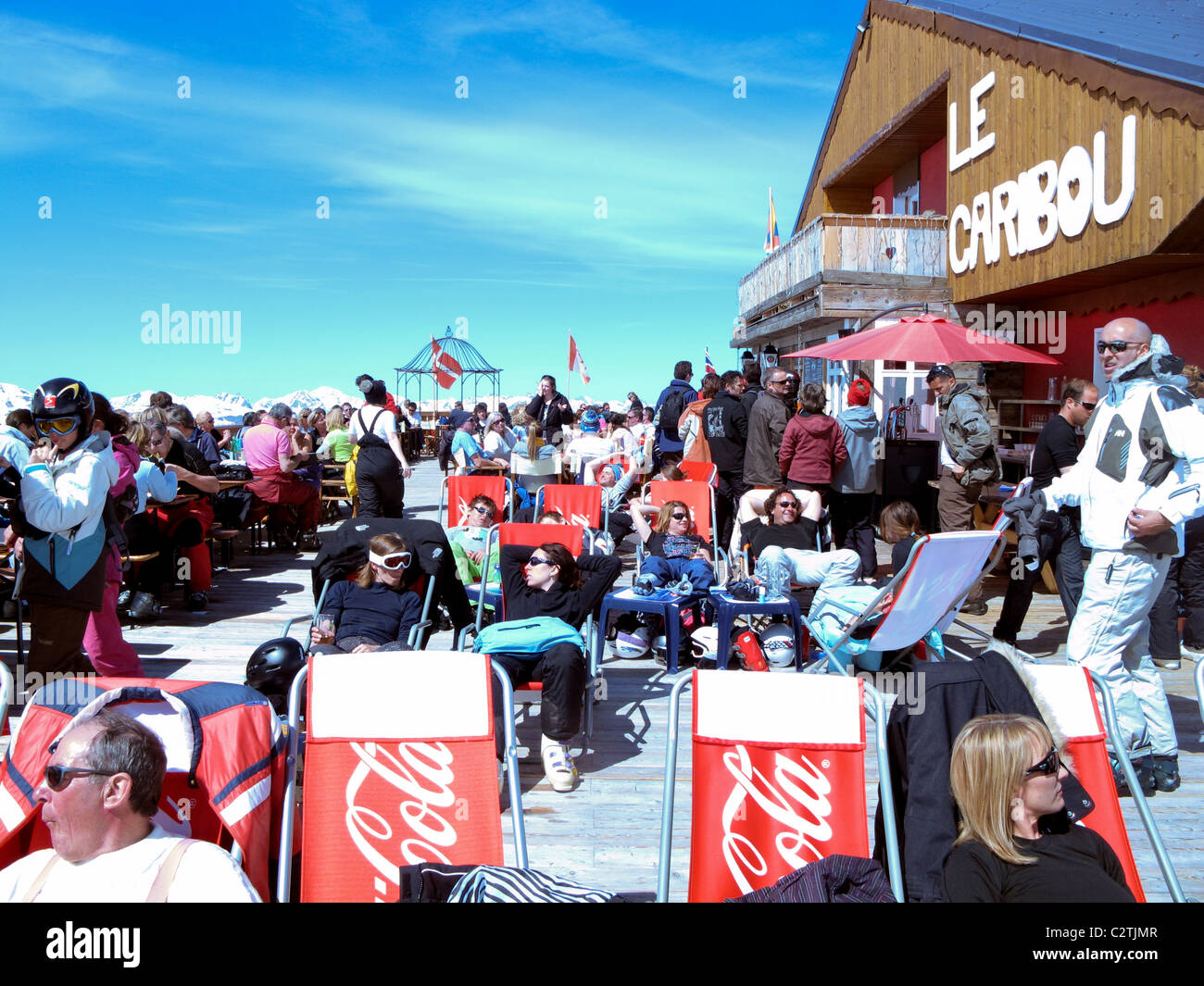 Skiers enjoying a rest at the Le caribou cafe restaurant in the French ...