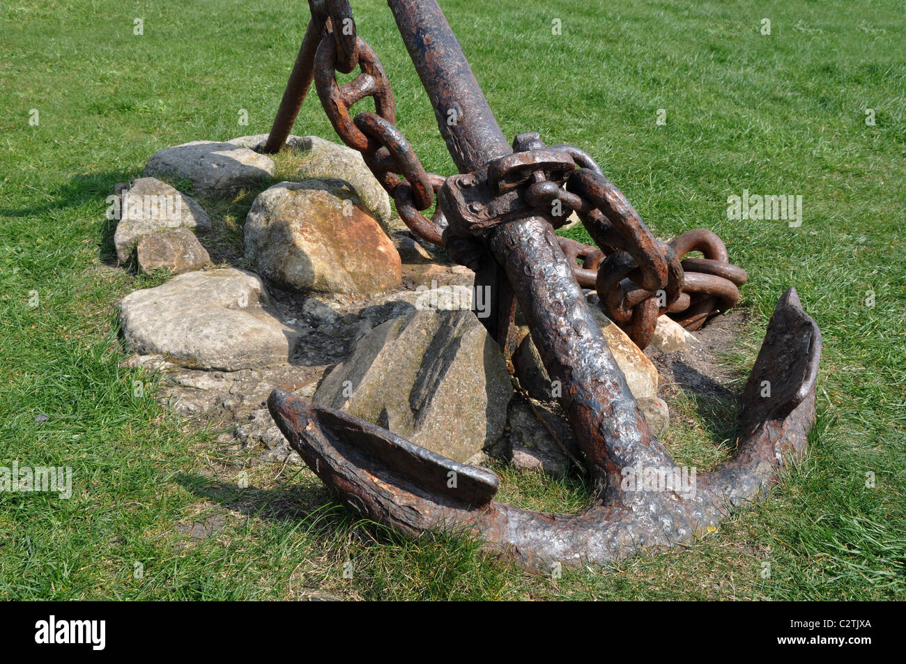 Anchor on rocks Stock Photo - Alamy