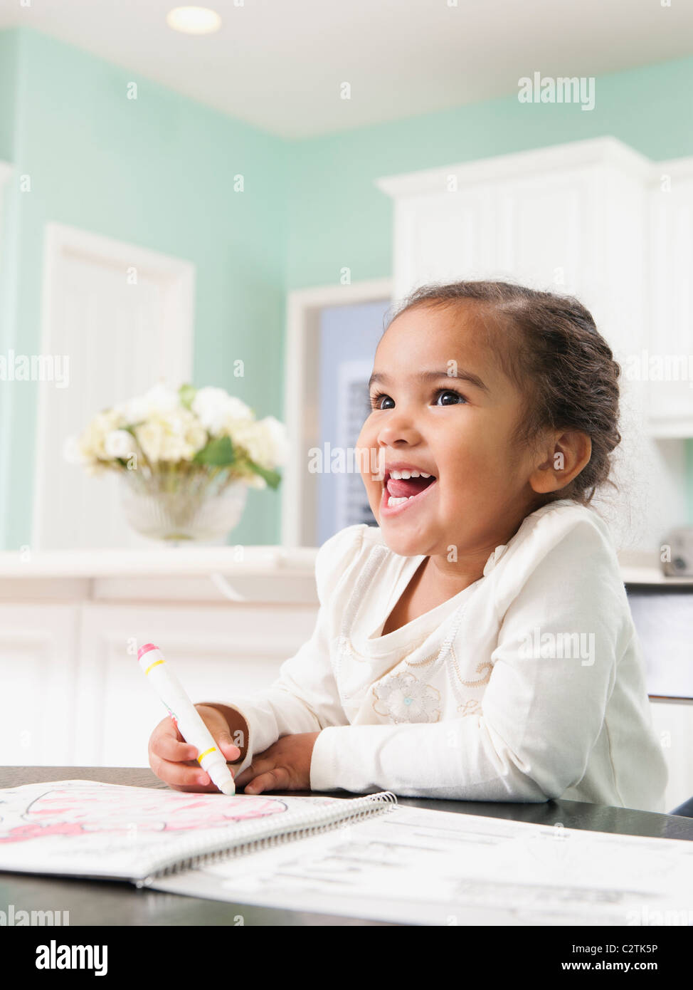Mixed race girl drawing in notebook Stock Photo - Alamy