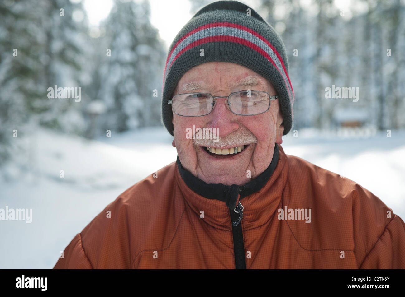 Elderly man in snowy winter scene Stock Photo - Alamy