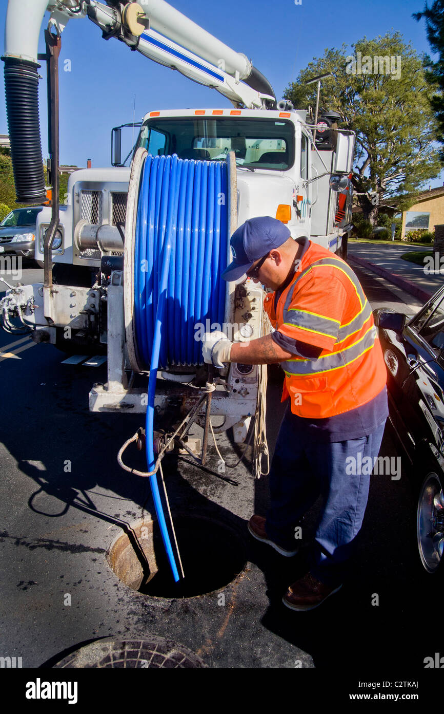 Using A Truck Mounted Suction System A Technician Cleans A Clogged