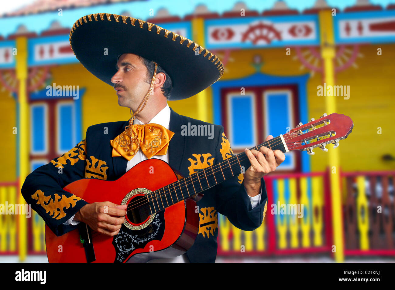 Charro Mariachi singer playing guitar in Mexico houses background Stock ...