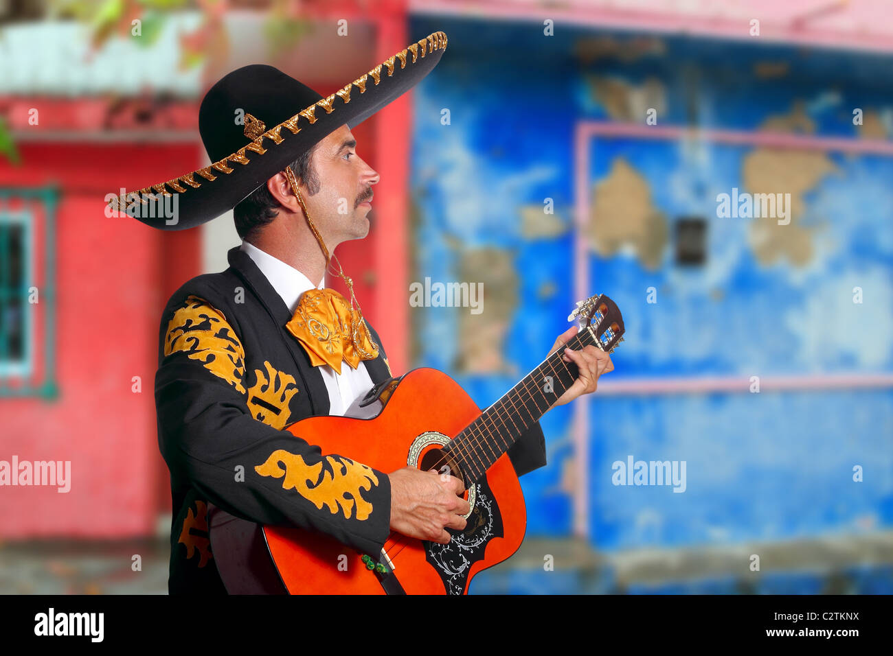 Charro Mariachi singer playing guitar in Mexico houses background Stock ...