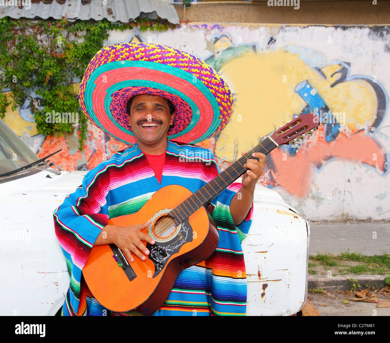 Mexican humor man smiling playing guitar sombrero poncho in street ...