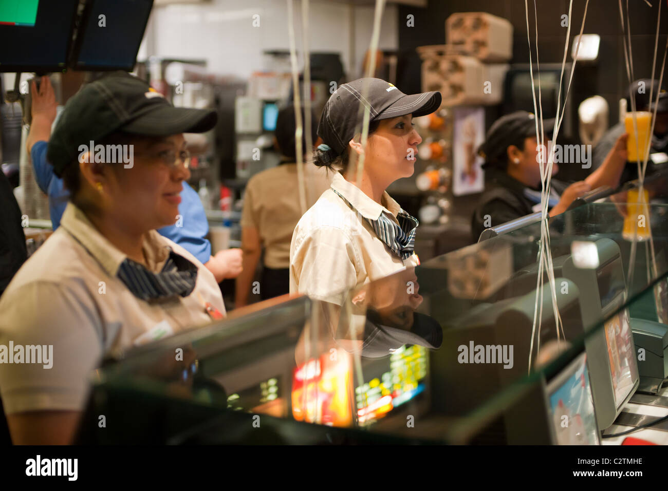 Employees of a McDonald's restaurant in New York serve customers Stock ...