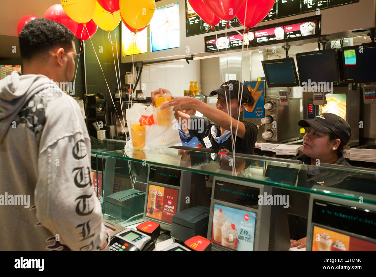 Employees of a McDonald's restaurant in New York serve customers Stock ...