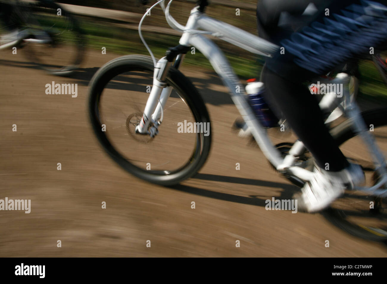 person riding fast bike on rural country path lane Stock Photo - Alamy