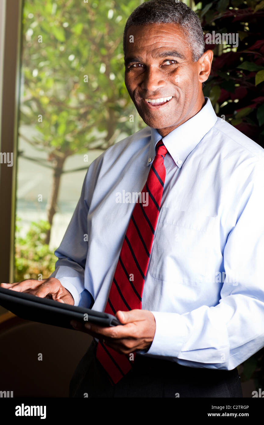 African American businessman using electronic tablet Stock Photo - Alamy
