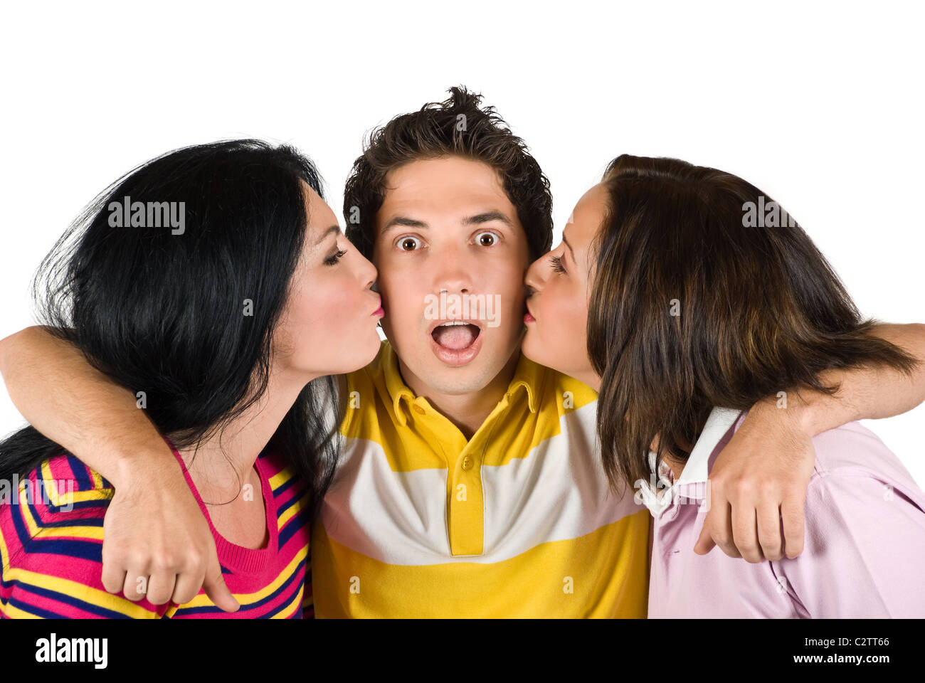 Young man making a surprised funny face in the middle of two woman who ...