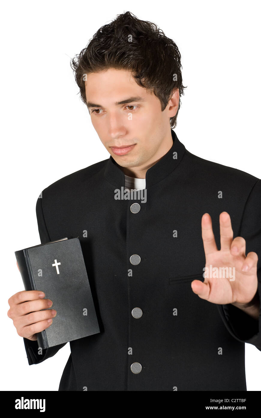 Young man priest thoughtful with bible and peace sign praying and need ...