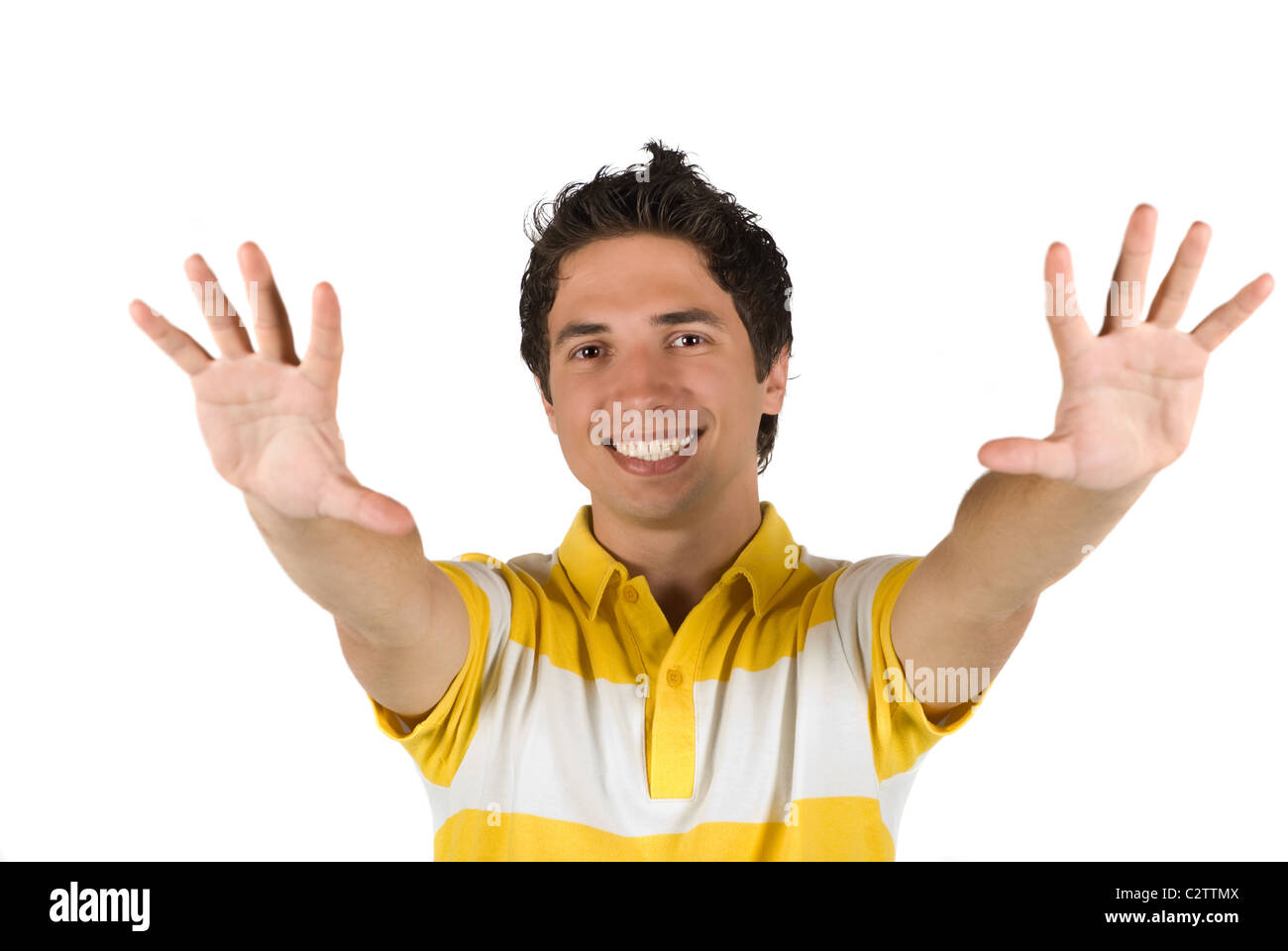 Cheerful young man with open hands in front isolated on white ...