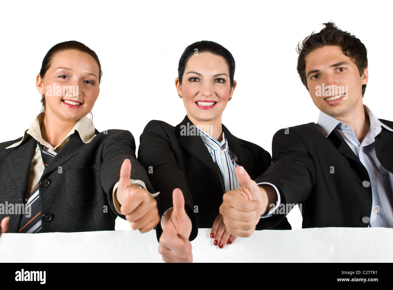 Business team showing a group of three thumbs up and holding a white ...