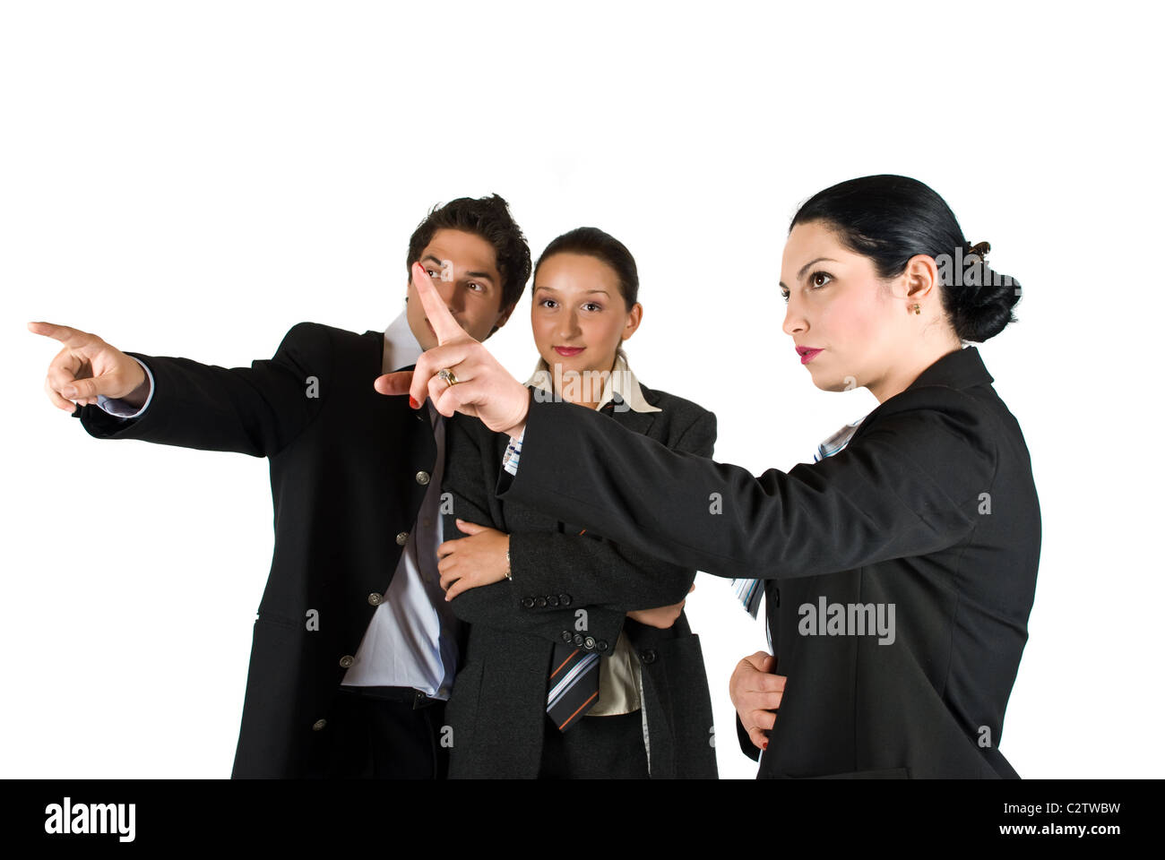Three business people at meeting pointing ,showing something to each ...