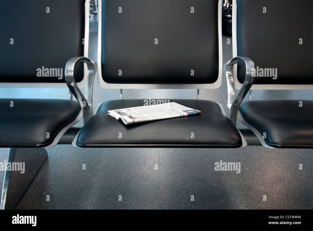 modern airport bench seating with newspaper Stock Photo - Alamy