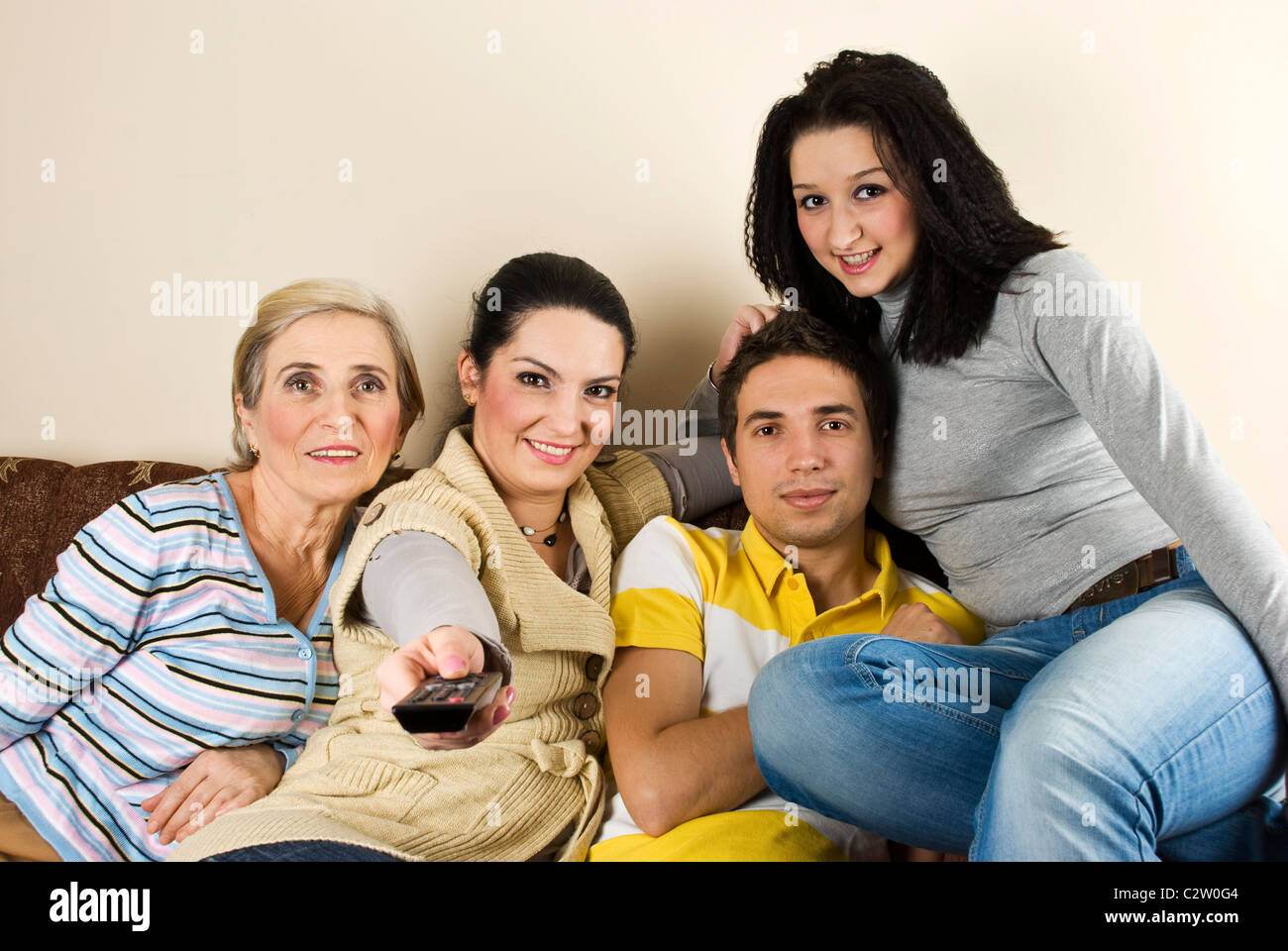 Happy group of friends or family watching tv and smiling Stock Photo ...