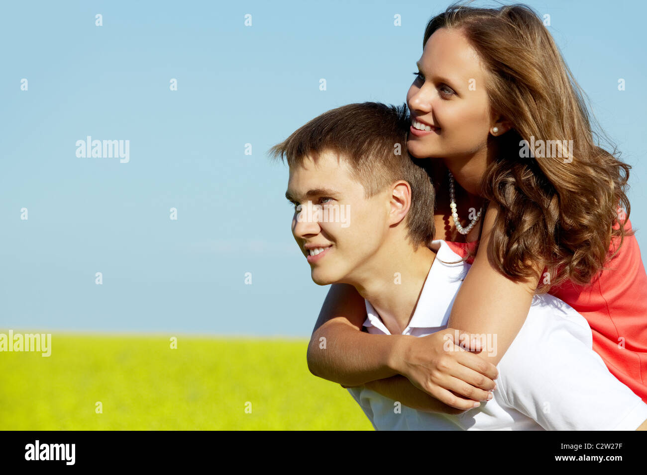 Pretty girl embracing handsome boyfriend while both laughing Stock ...