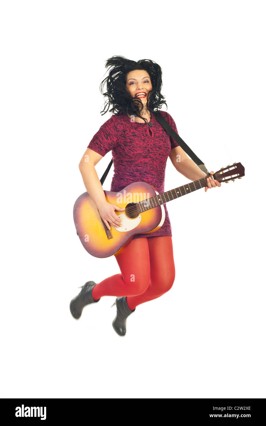 Cheerful guitarist woman jumping and holding guitar isolated on white ...