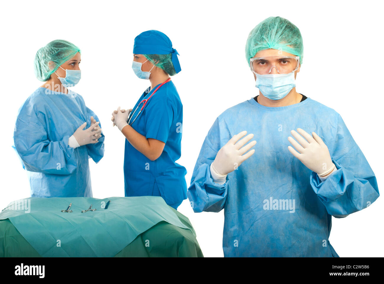 Surgeon in uniform ready for operation and his team having conversation ...