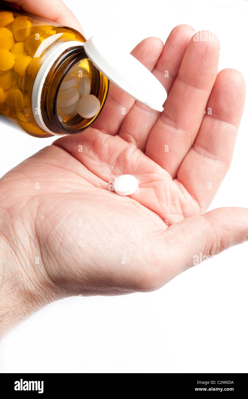 pouring pills into hand Stock Photo - Alamy